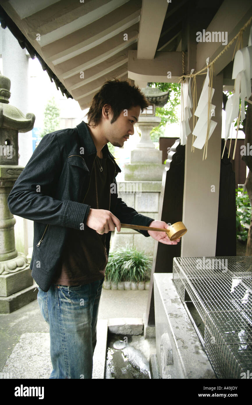 Side profile of a young man holding a ladle Stock Photo - Alamy