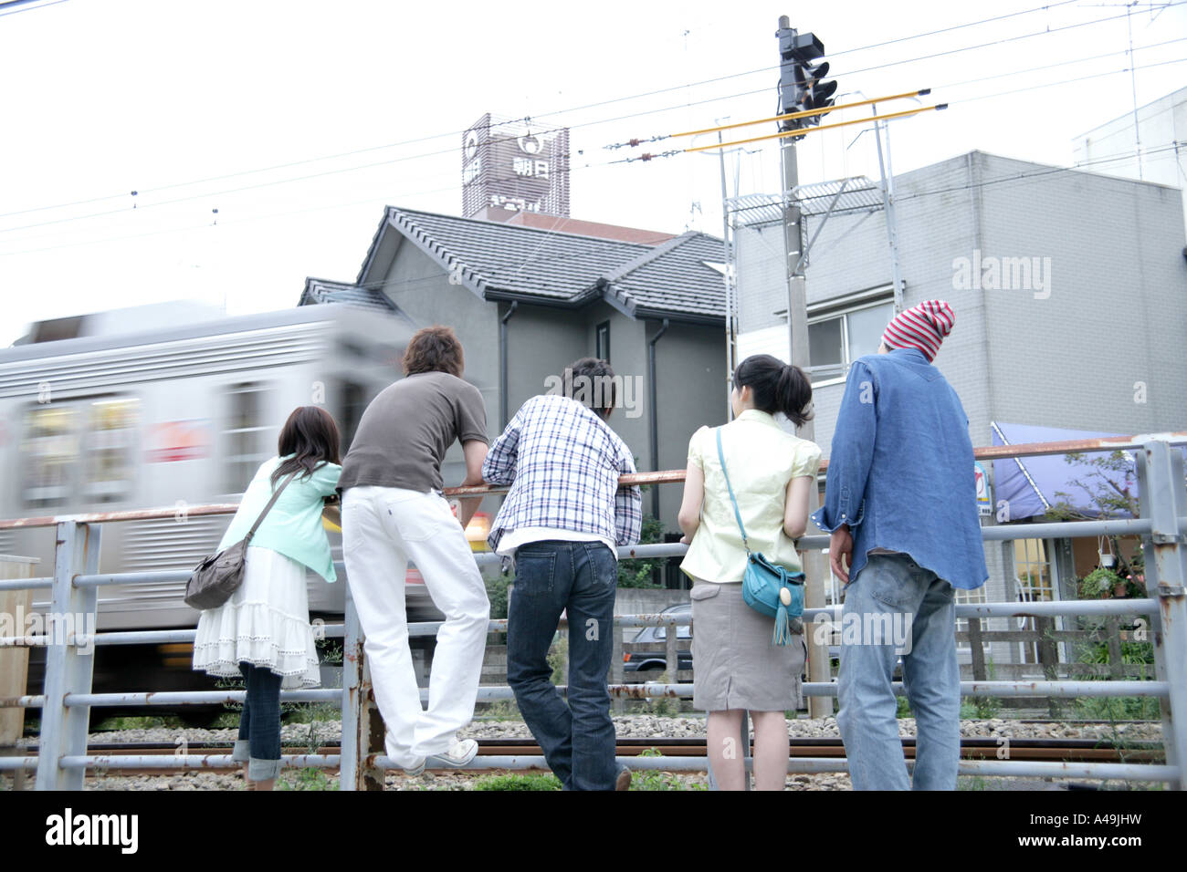 People leaning against railing blurred hi-res stock photography and ...