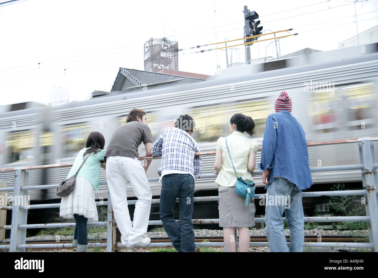 People leaning against railing blurred hi-res stock photography and ...