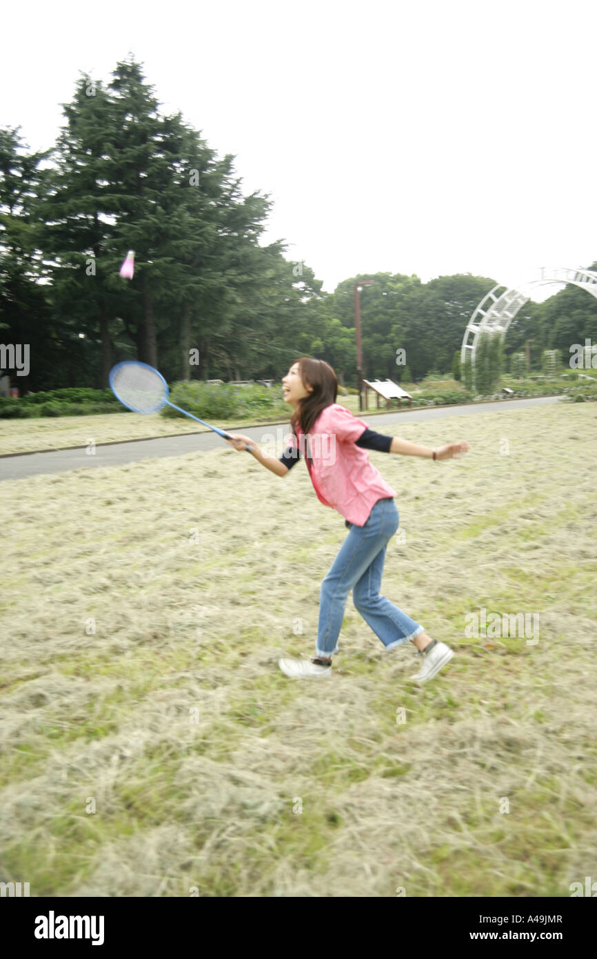 Side profile of a young woman playing badminton Stock Photo - Alamy