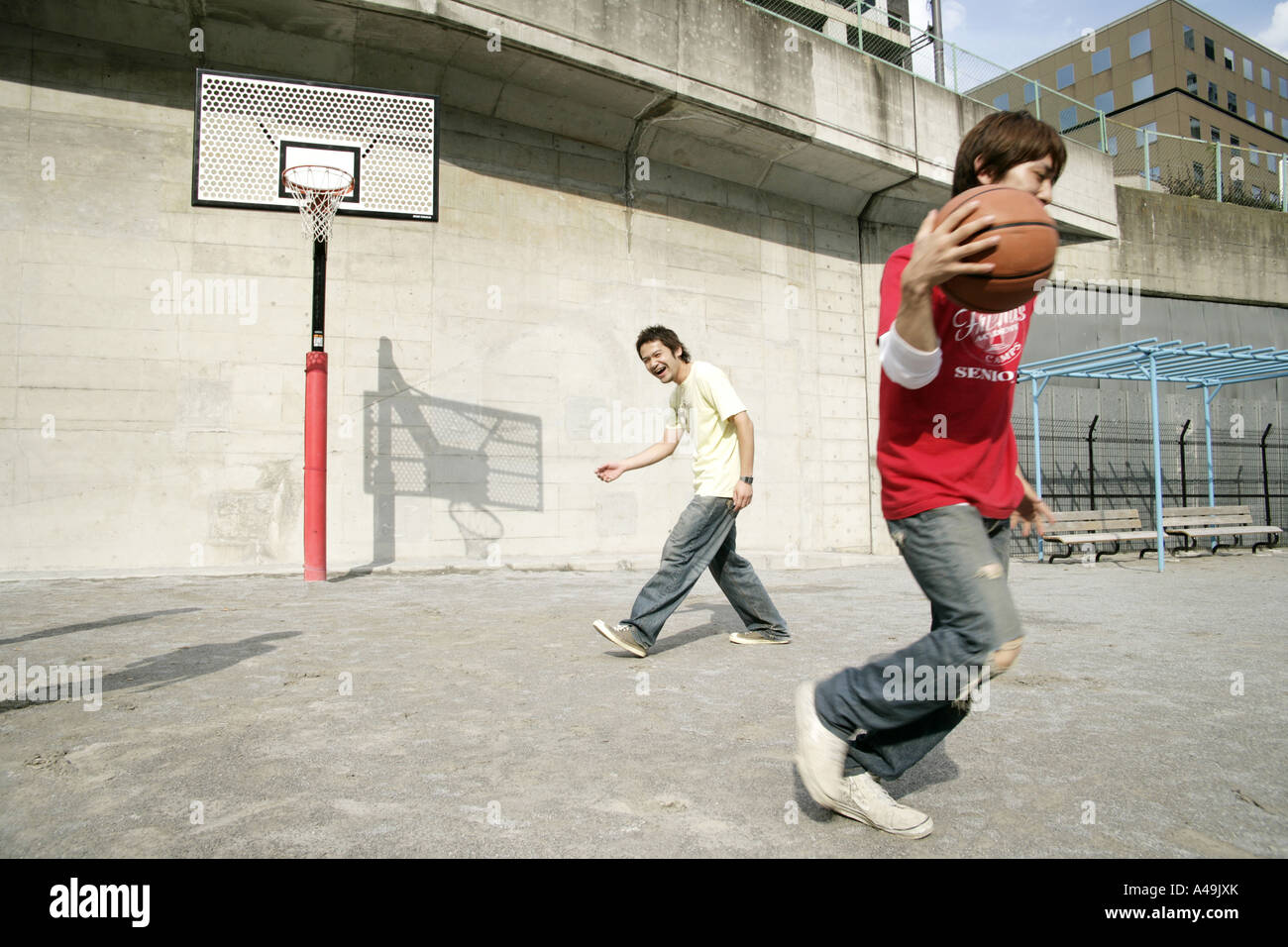 Two young men playing basketball Stock Photo - Alamy