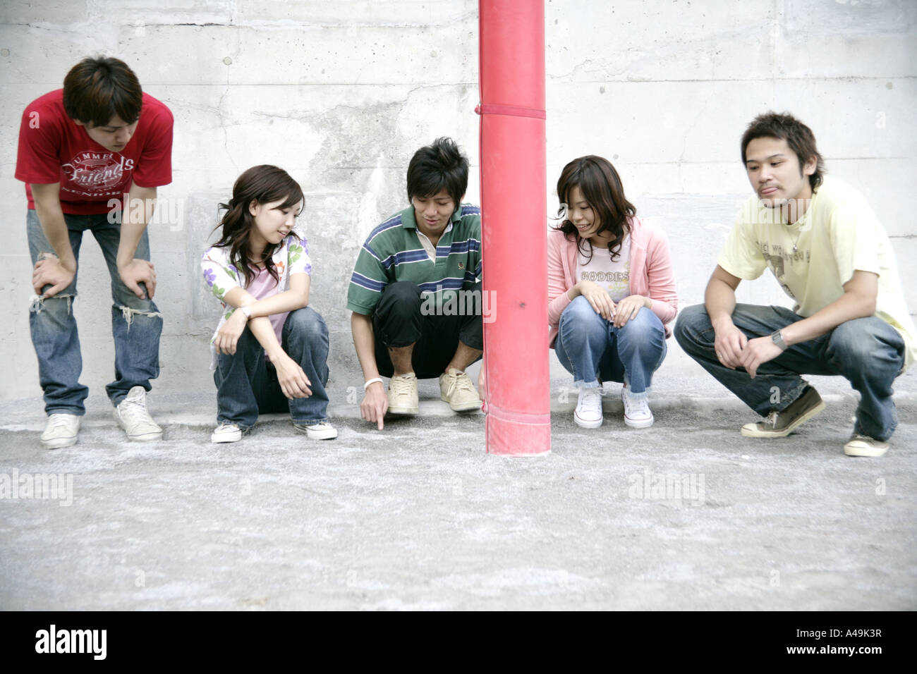 Three young men and two young women making a game plan Stock Photo - Alamy