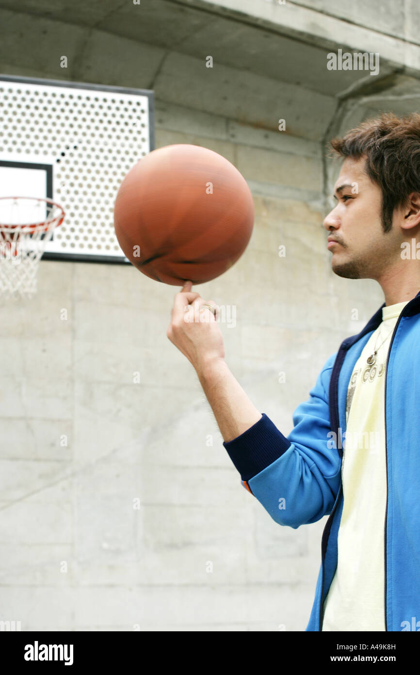 Side profile of a young man spinning a ball Stock Photo - Alamy