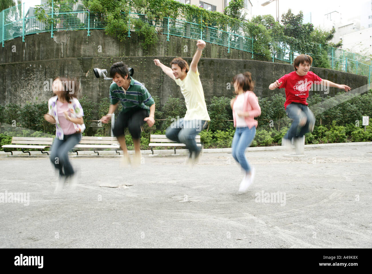 Five people jumping on a jump rope Stock Photo - Alamy