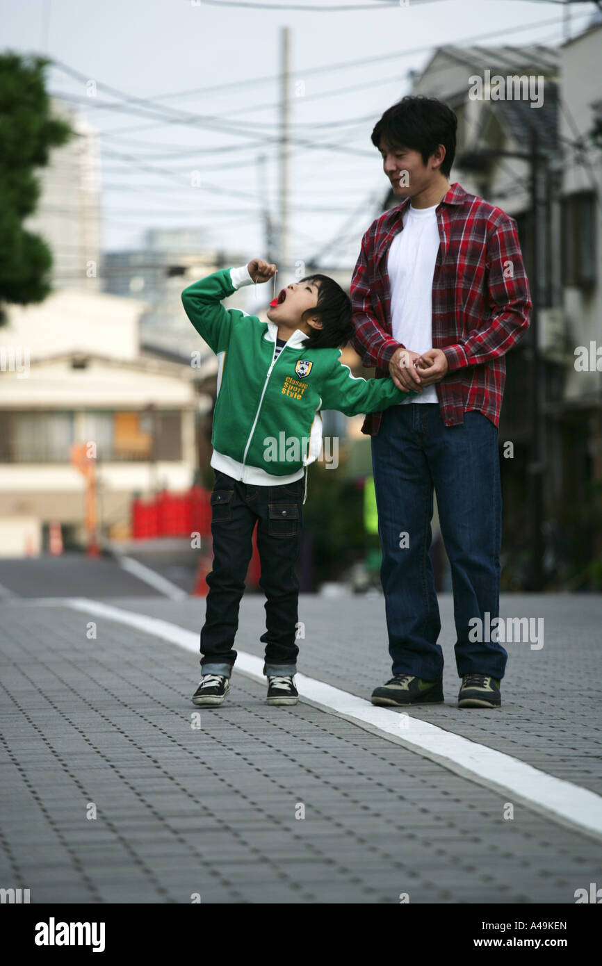 Young man standing and holding his father s hand Stock Photo - Alamy