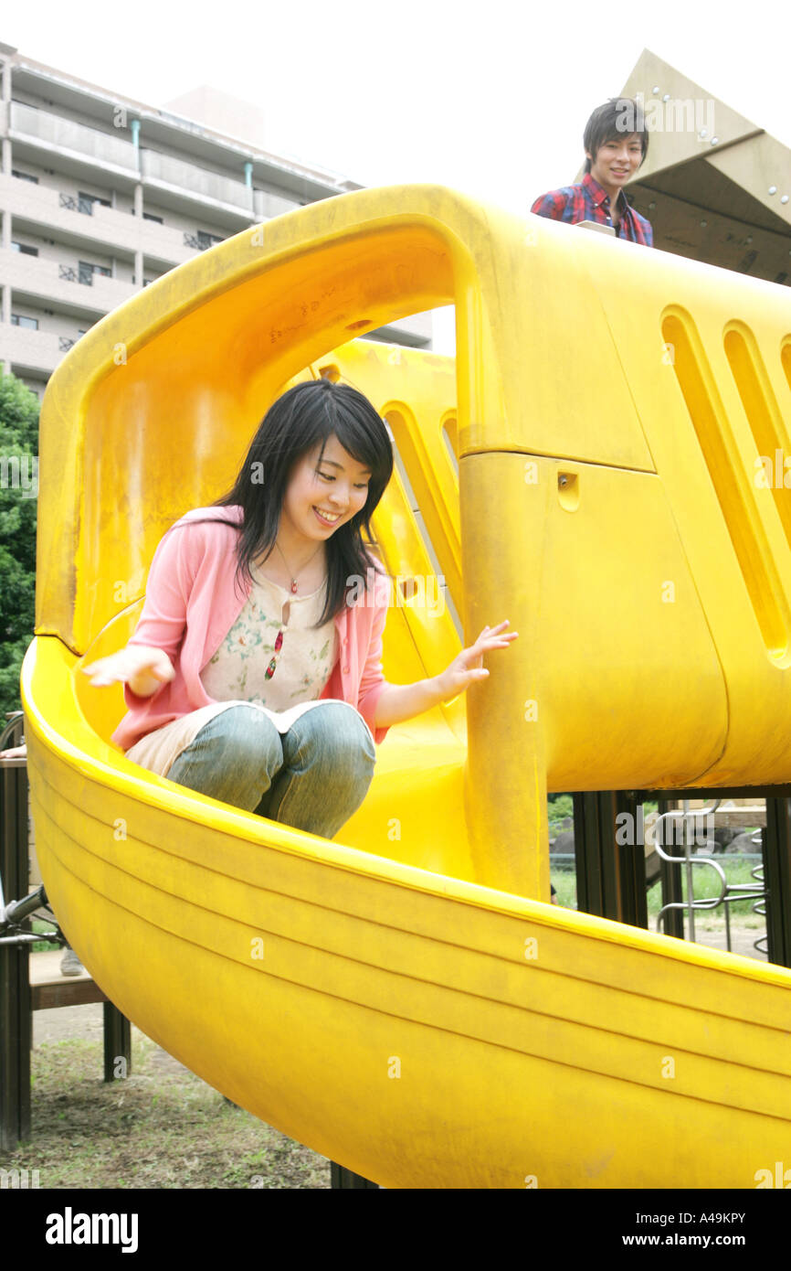 Young woman sliding on a slide Stock Photo - Alamy