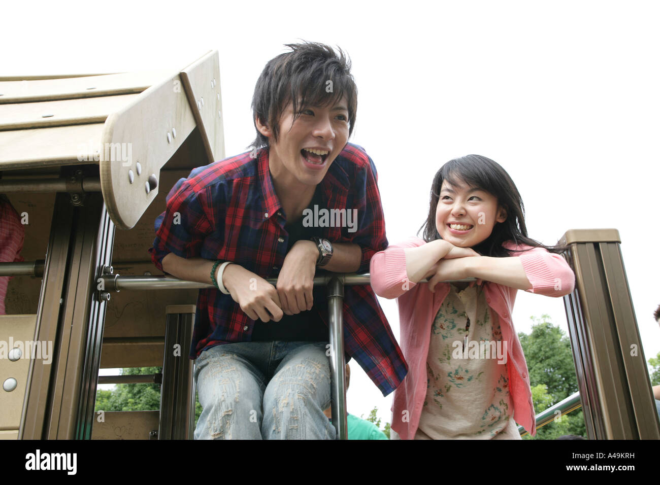 Low angle view of a young couple bending forward over a railing Stock ...