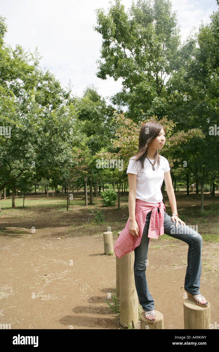 Side profile of a young woman standing on wooden posts Stock Photo - Alamy