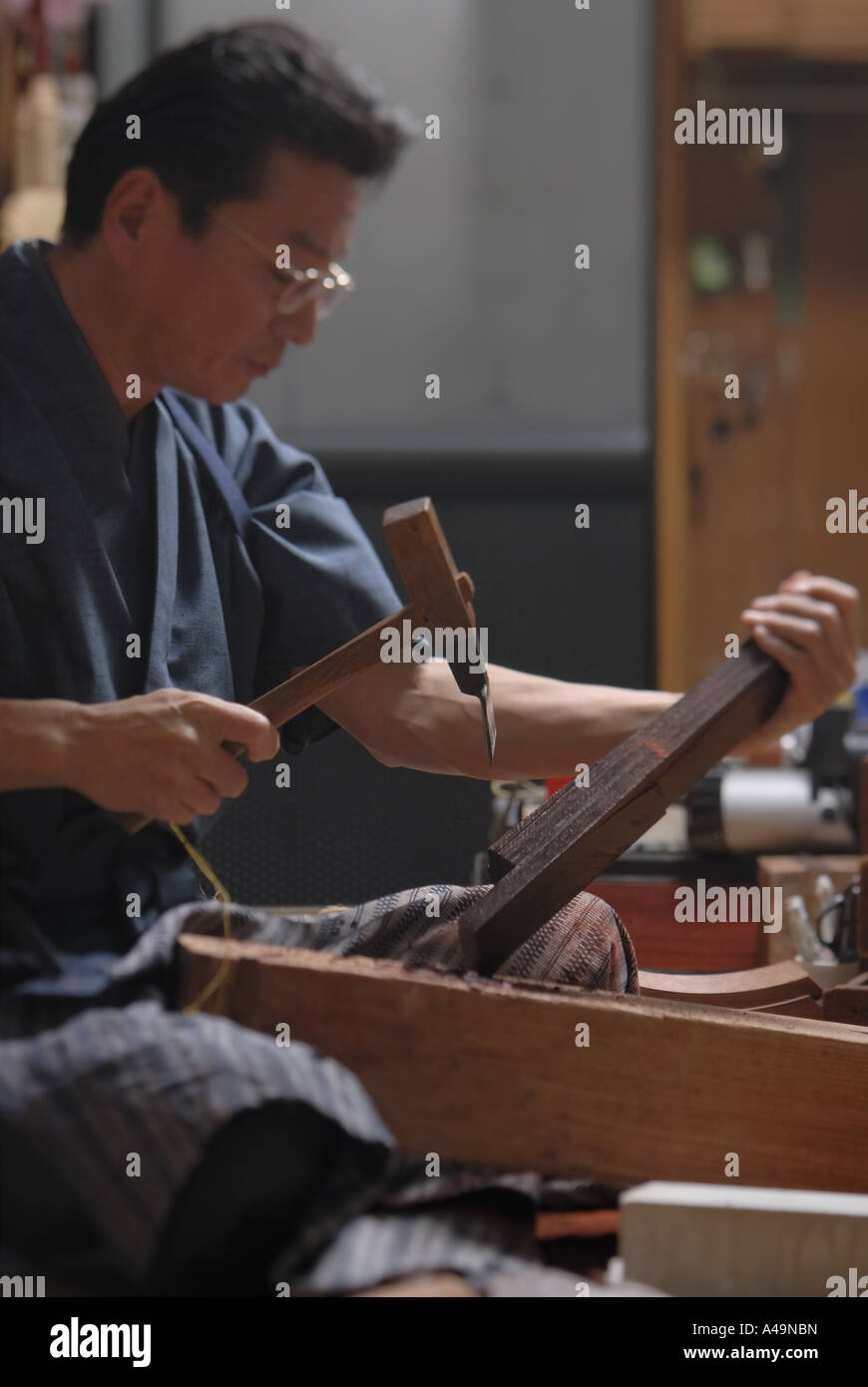 Side profile of a mature man hammering wood Stock Photo - Alamy