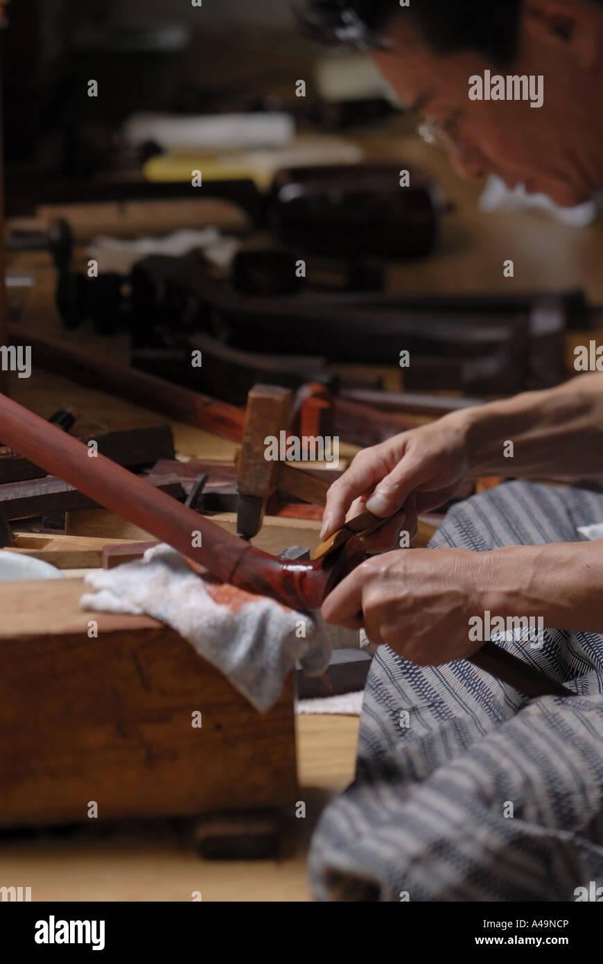 Side profile of a carpenter applying paint on wood Stock Photo - Alamy