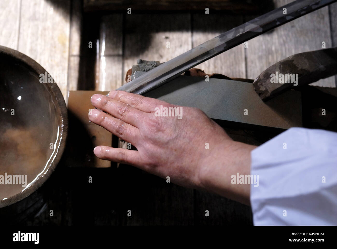 High angle view of a blacksmith s hand sharpening a sword Stock Photo ...