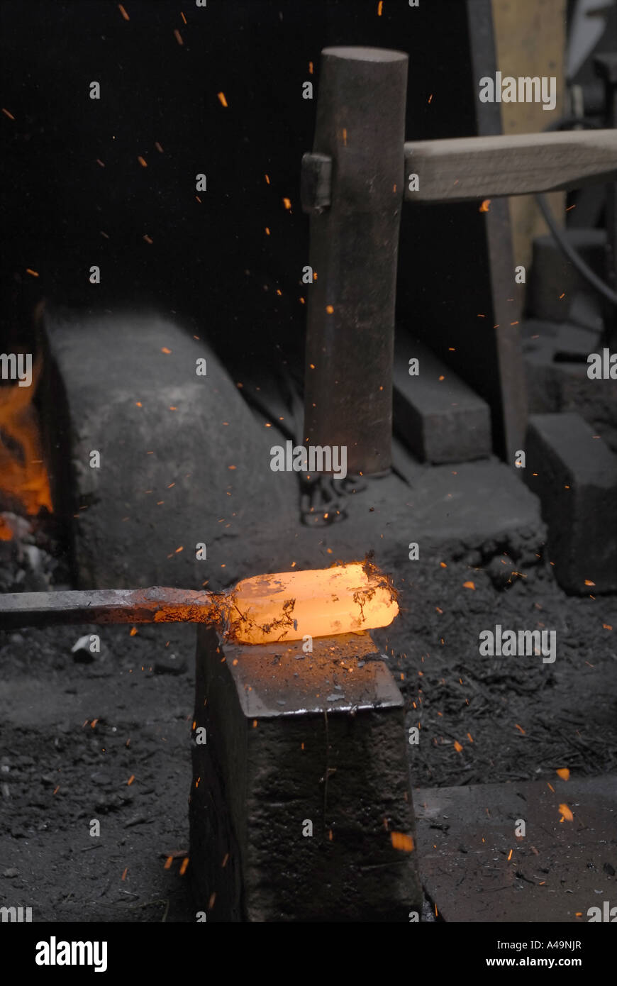Close up of a hammer hitting a heated metal rod Stock Photo - Alamy