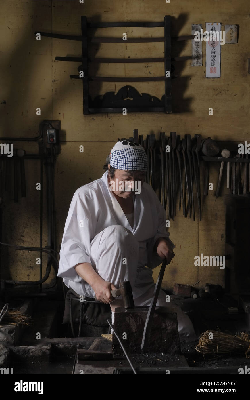 Blacksmith working on a sword in a workshop Stock Photo - Alamy