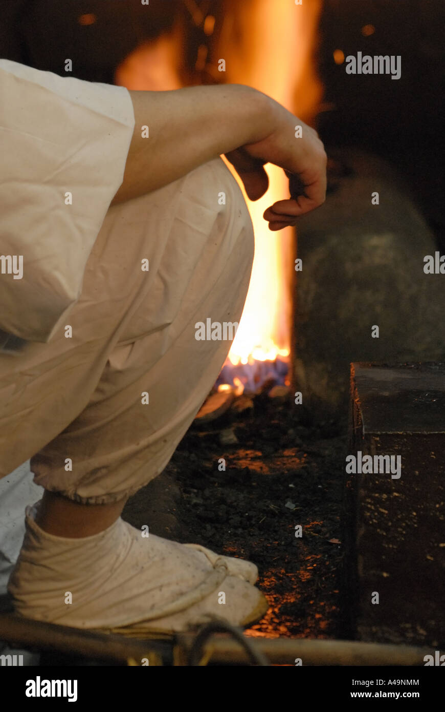 Low section view of a blacksmith sitting near a furnace Stock Photo - Alamy