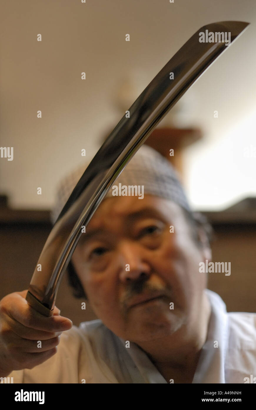 Blacksmith examining a sword Stock Photo - Alamy