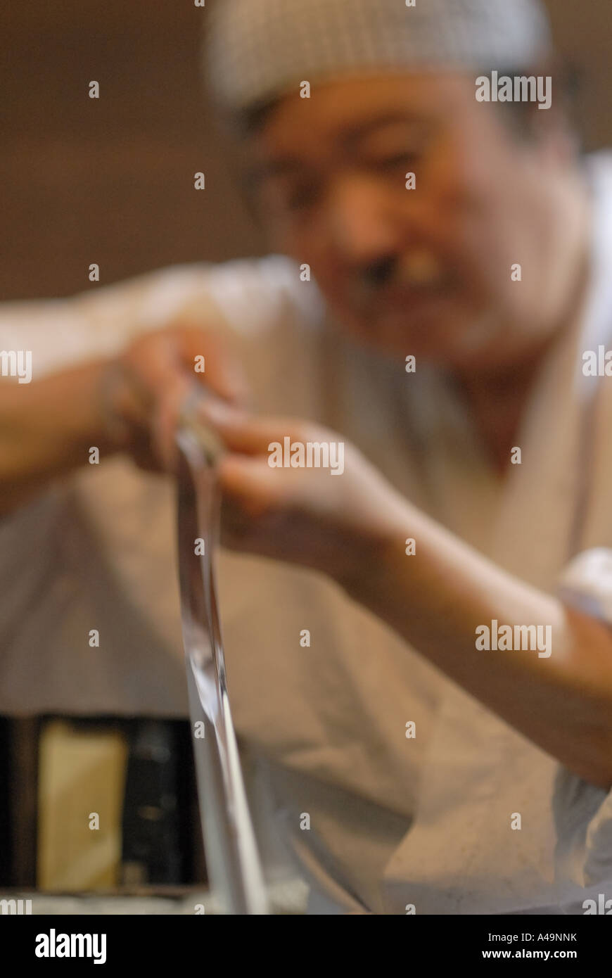 Blacksmith examining a sword Stock Photo - Alamy
