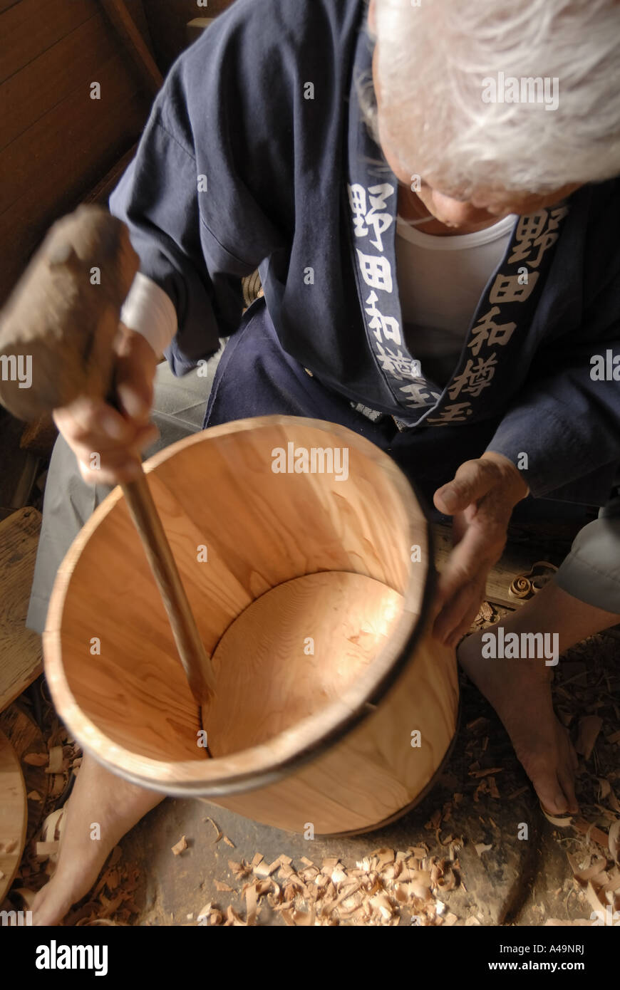 High angle view of a carpenter hitting a barrel with a mallet Stock ...
