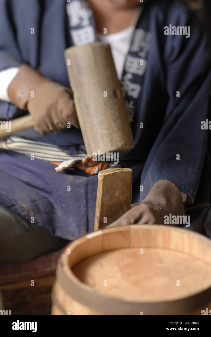 Mid section view of a carpenter hitting a barrel with a mallet Stock ...