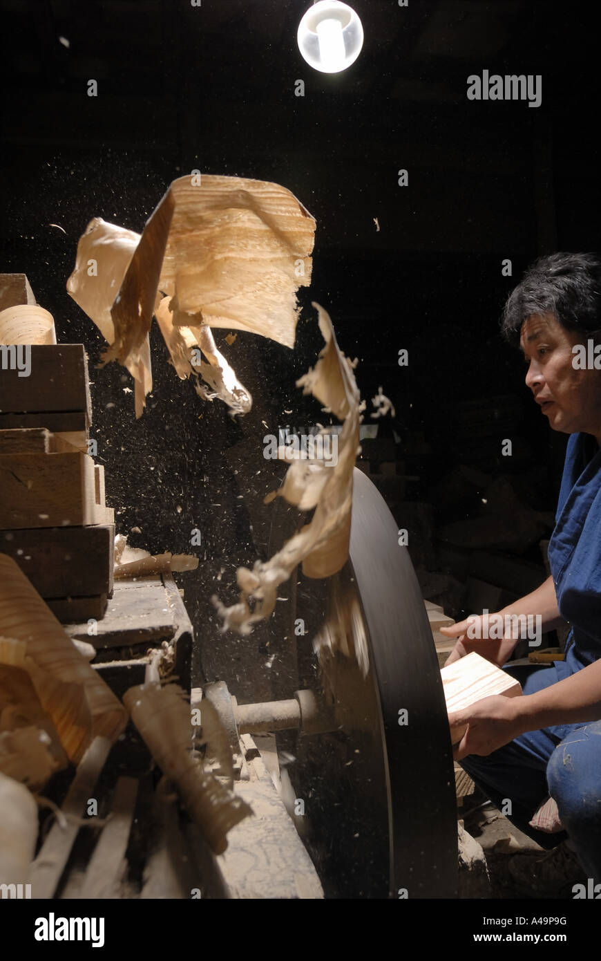 Side profile of a carpenter cutting wood in a workshop Stock Photo - Alamy