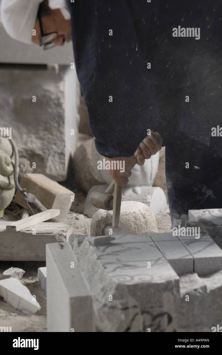 Side profile of a sculptor craving stones Stock Photo - Alamy