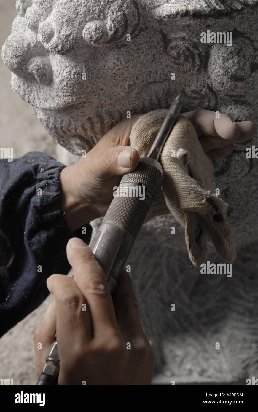 Close up of a person s hand carving a statue with a drill Stock Photo ...