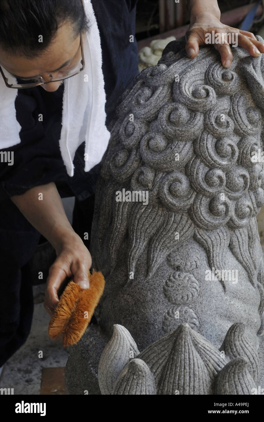 Close up of a sculptor cleaning a statue with a brush Stock Photo - Alamy