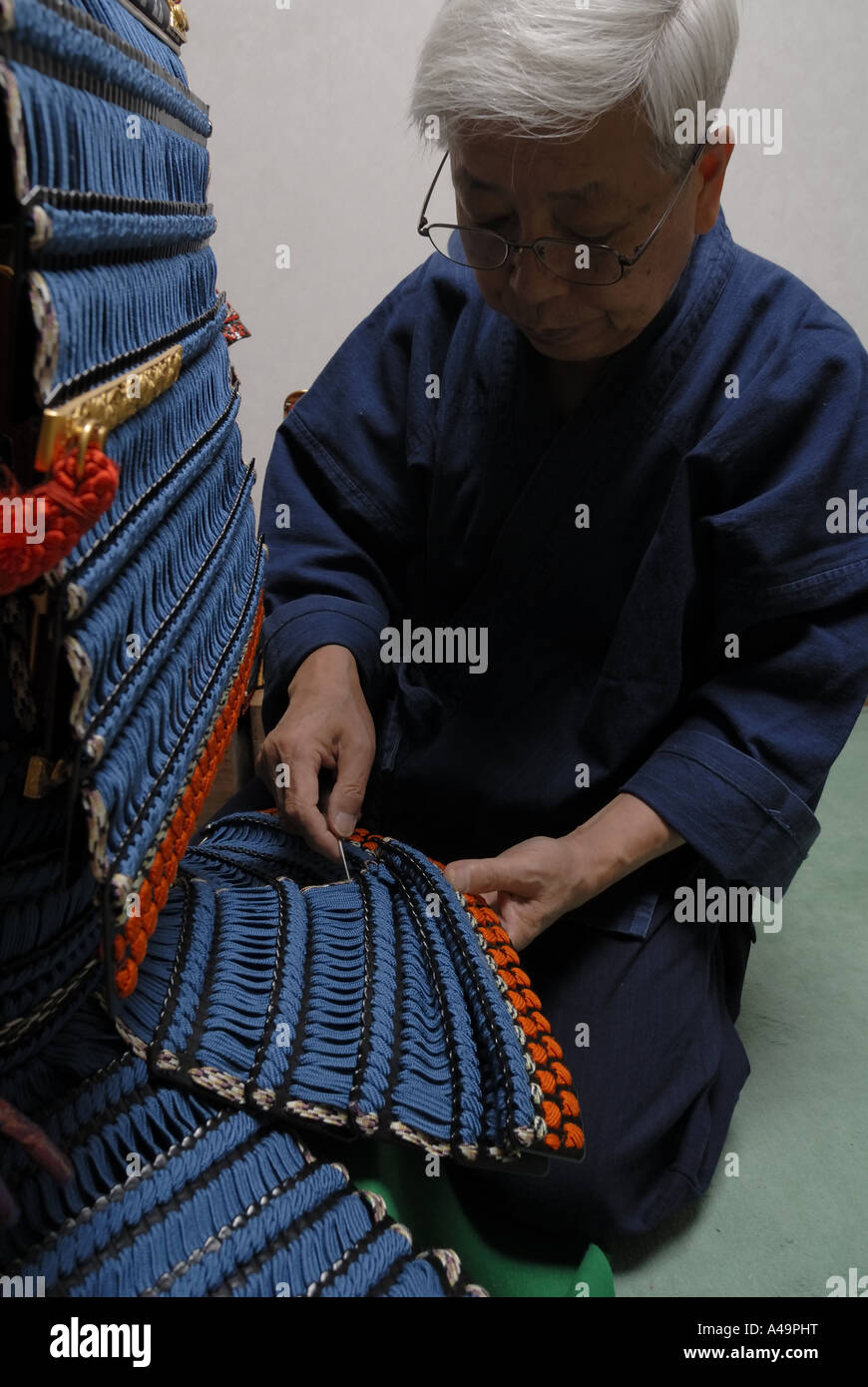 Close up of a person making a traditional costume with a work tool ...