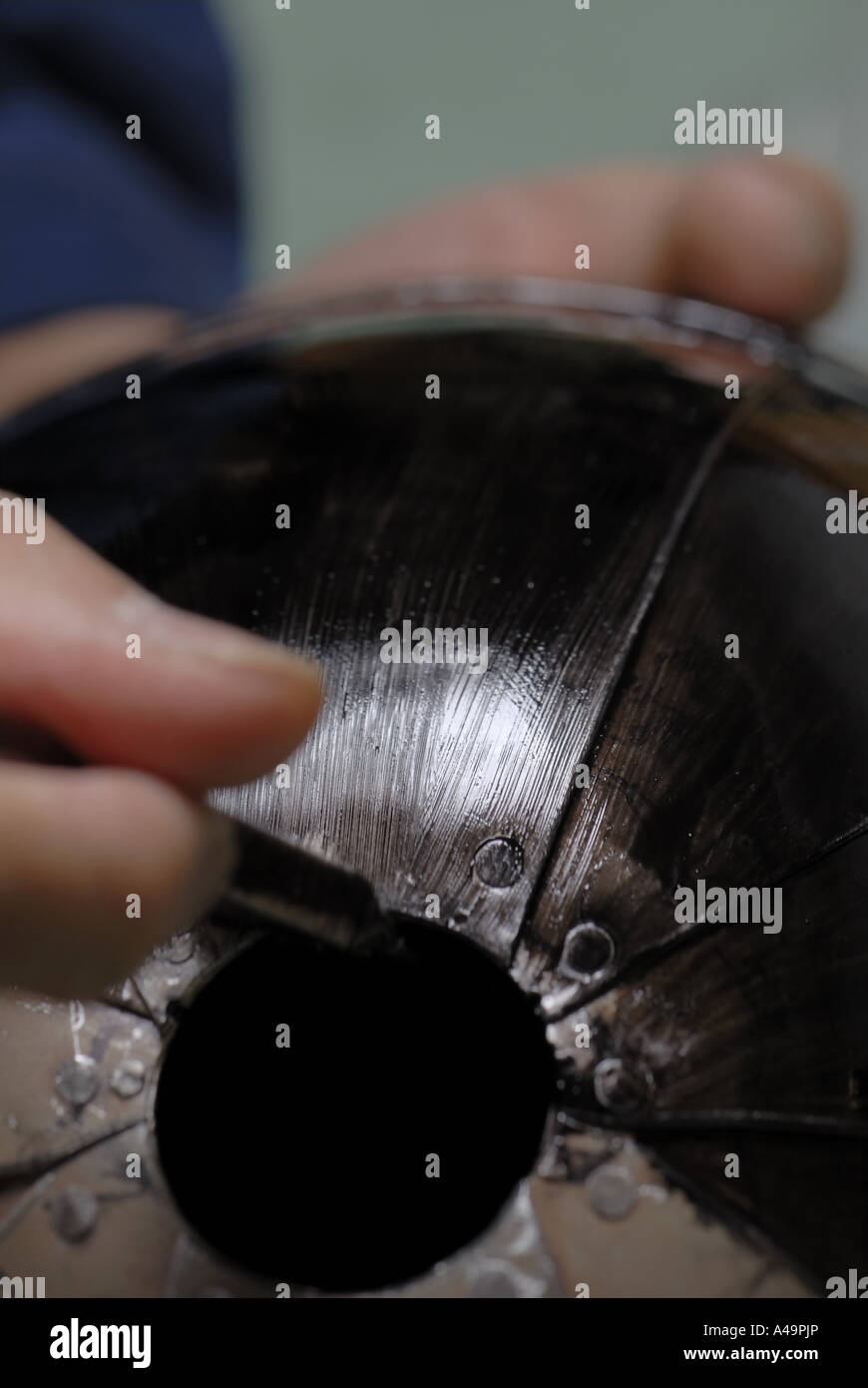 Close up of a person s hands making a helmet of armor Stock Photo - Alamy