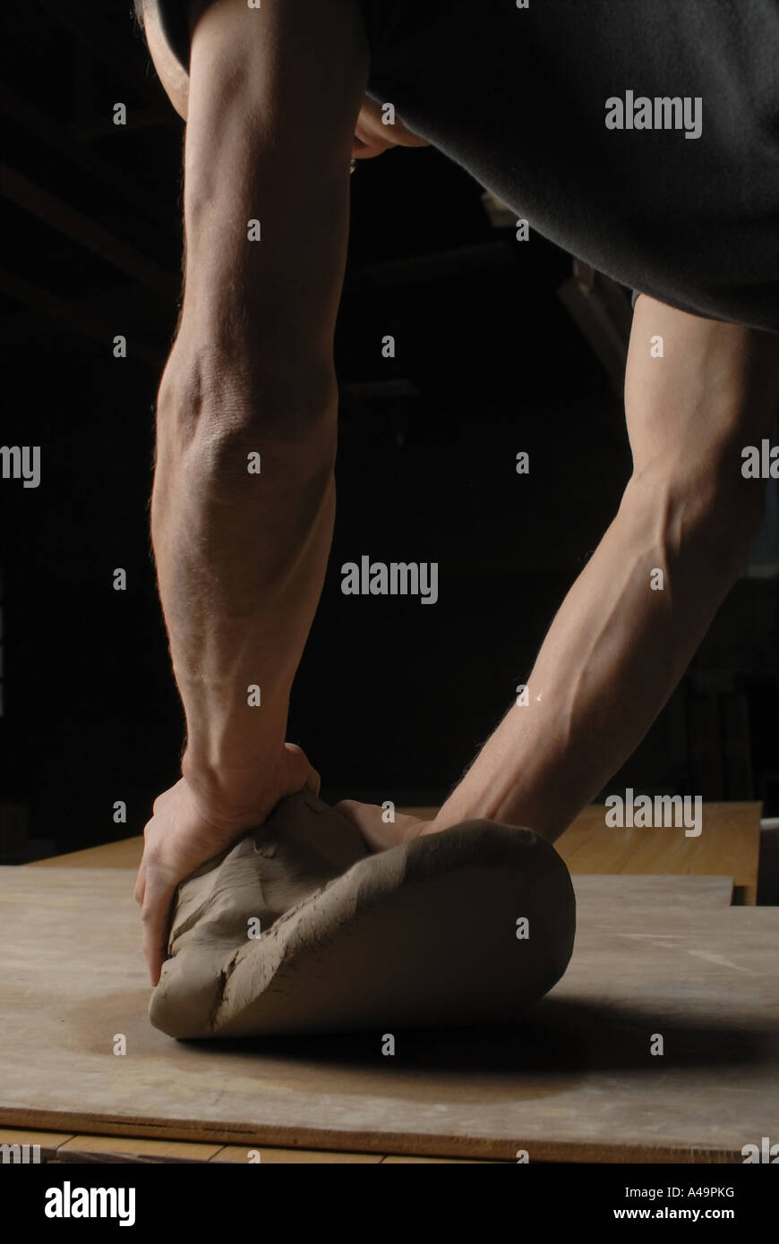 Side profile of a potter kneading clay Stock Photo - Alamy