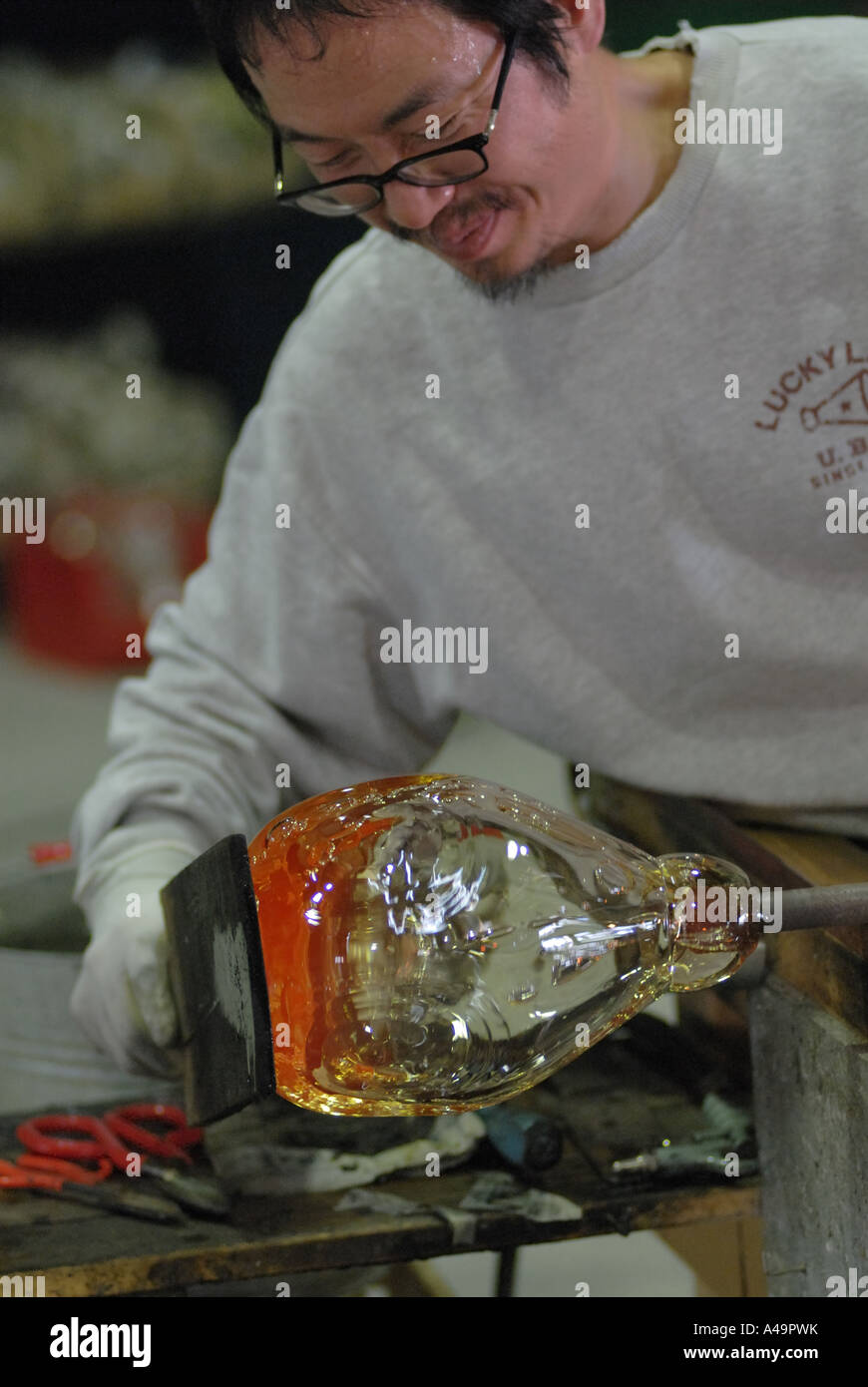 Close up of a mid adult man molding a glass bulb Stock Photo - Alamy