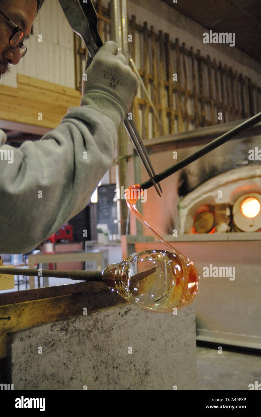 Side profile of a mid adult man molding a glass bulb Stock Photo - Alamy