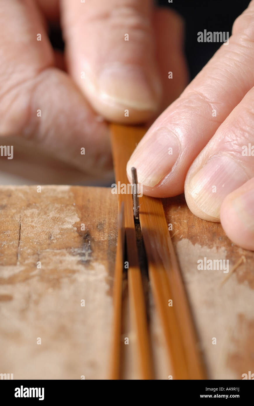 Close up of a person s hands dividing a wooden stick Stock Photo - Alamy
