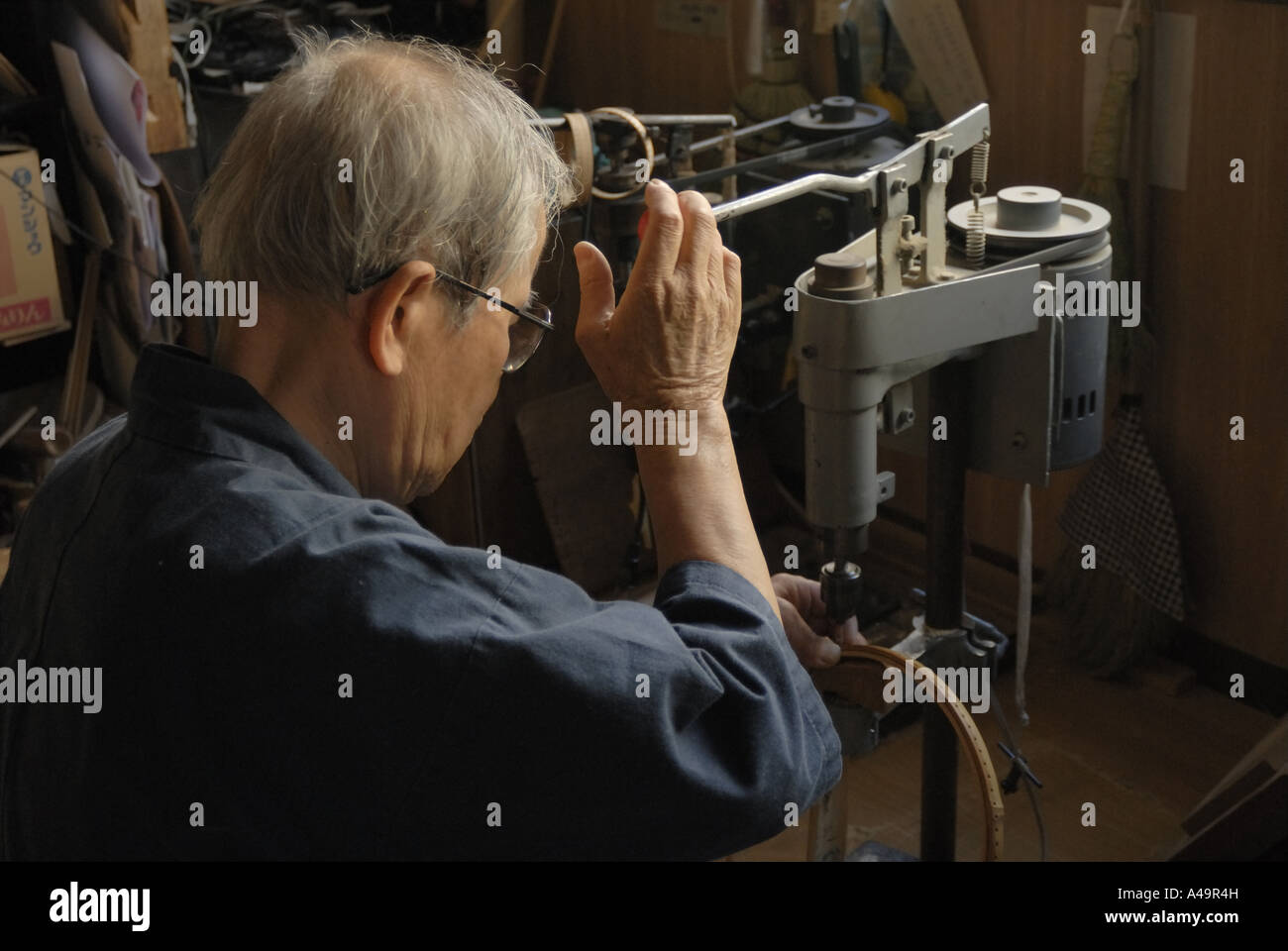 Rear view of a mature man using a machine Stock Photo - Alamy