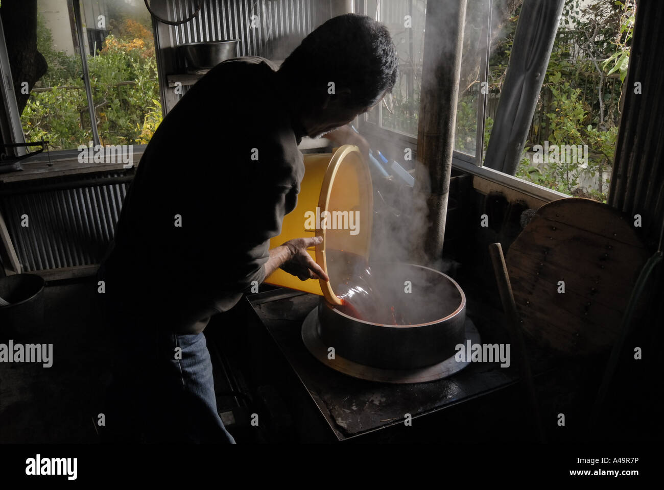 Side profile of a man pouring dye in a container Stock Photo - Alamy