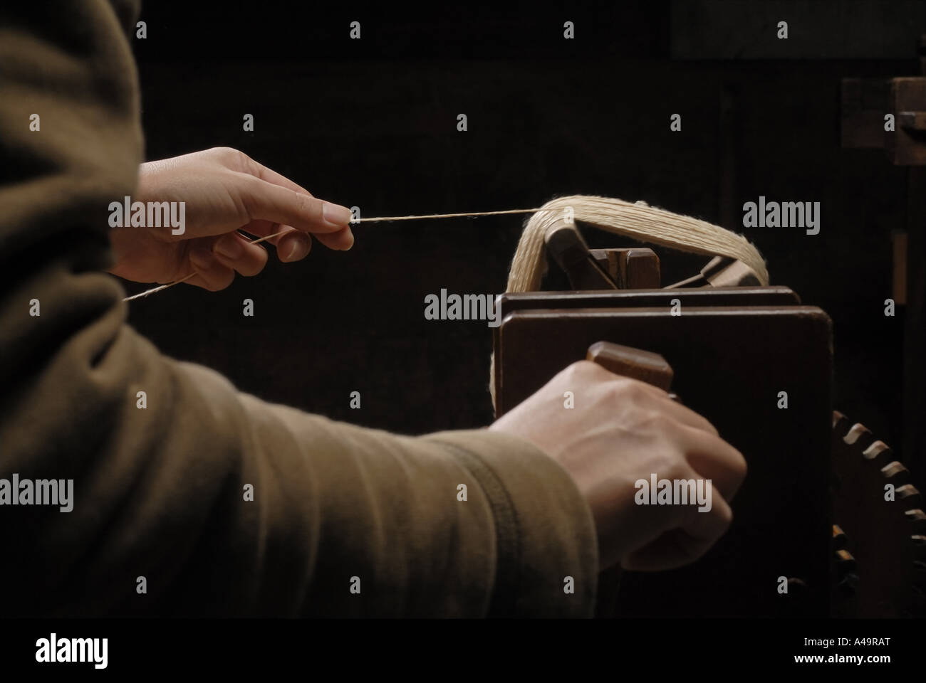 Close up of a person s hand working on a spinning wheel Stock Photo - Alamy