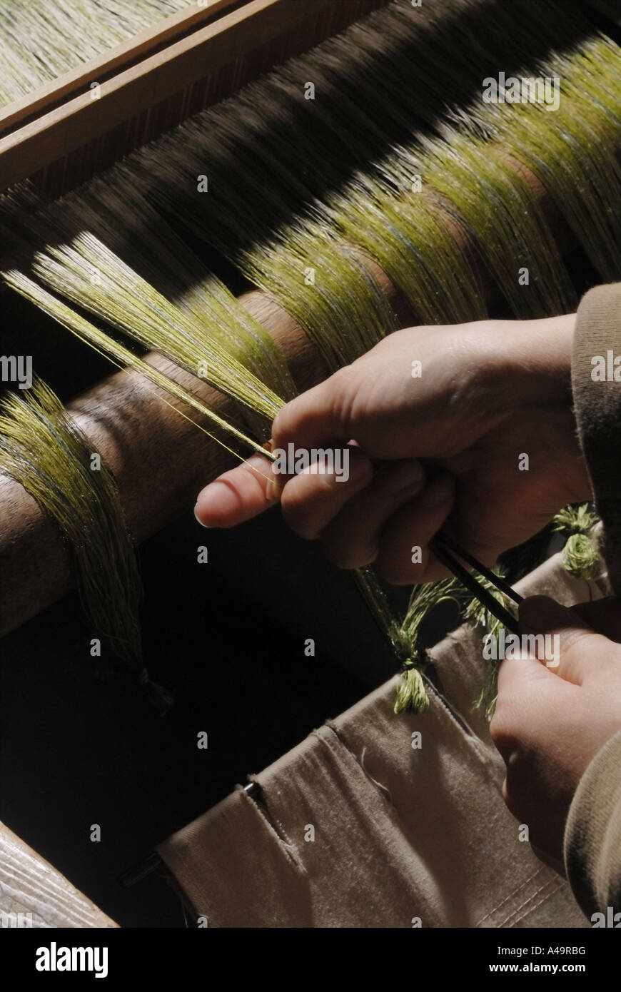 Close up of a person s hands working on a loom Stock Photo - Alamy