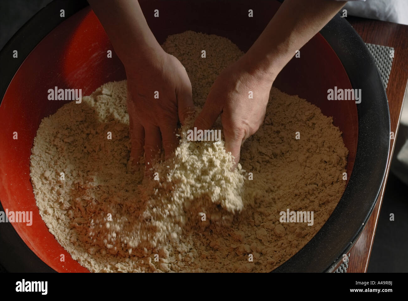 Close up of a person s hands mixing flour in a mixing bowl Stock Photo ...