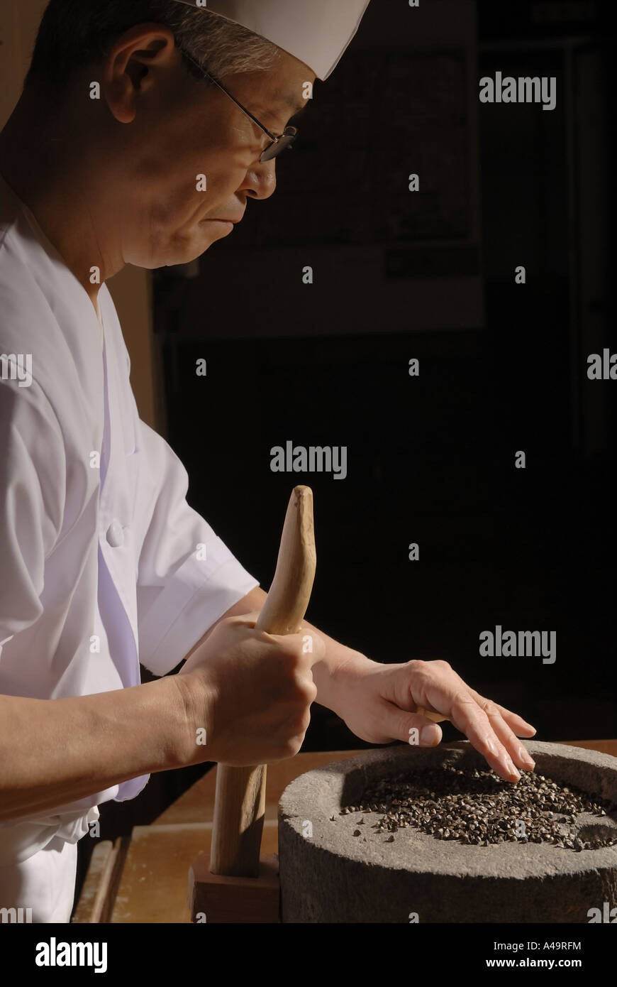 Side profile of a mature man grinding grain in a grinding stone Stock ...