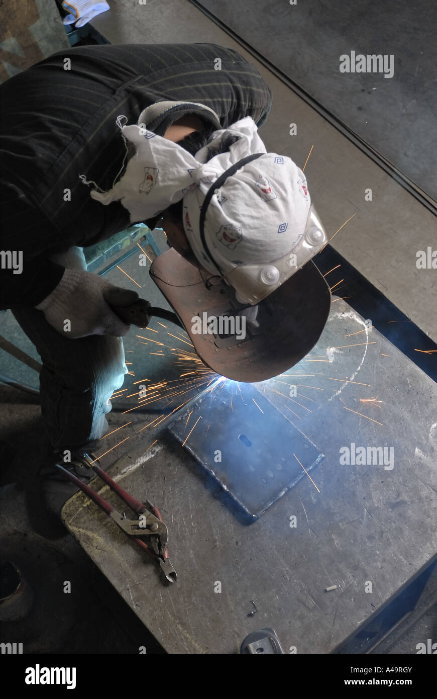High angle view of a welder welding in a workshop Stock Photo - Alamy