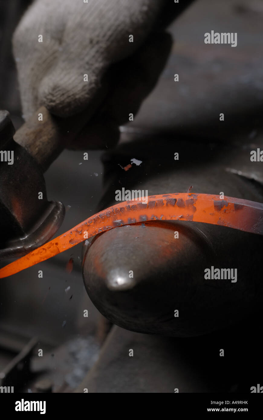 Close up of a person s hand bending a molten rod Stock Photo - Alamy