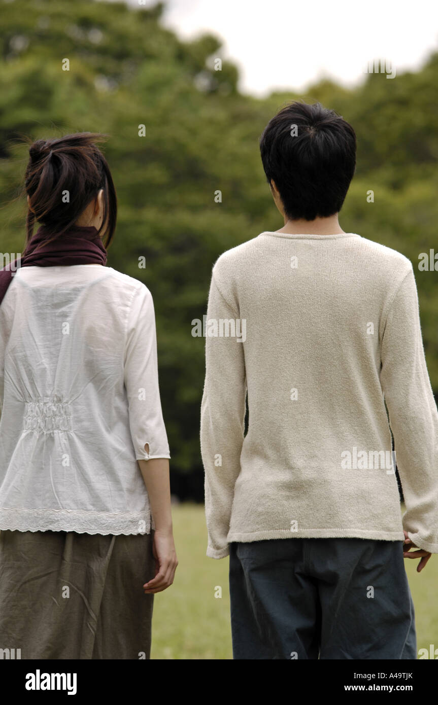 Rear View of a young couple standing together Stock Photo - Alamy