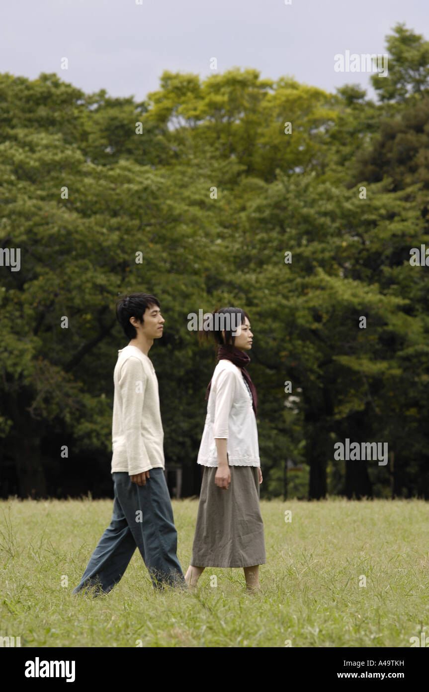 Side profile of a young couple walking together Stock Photo - Alamy