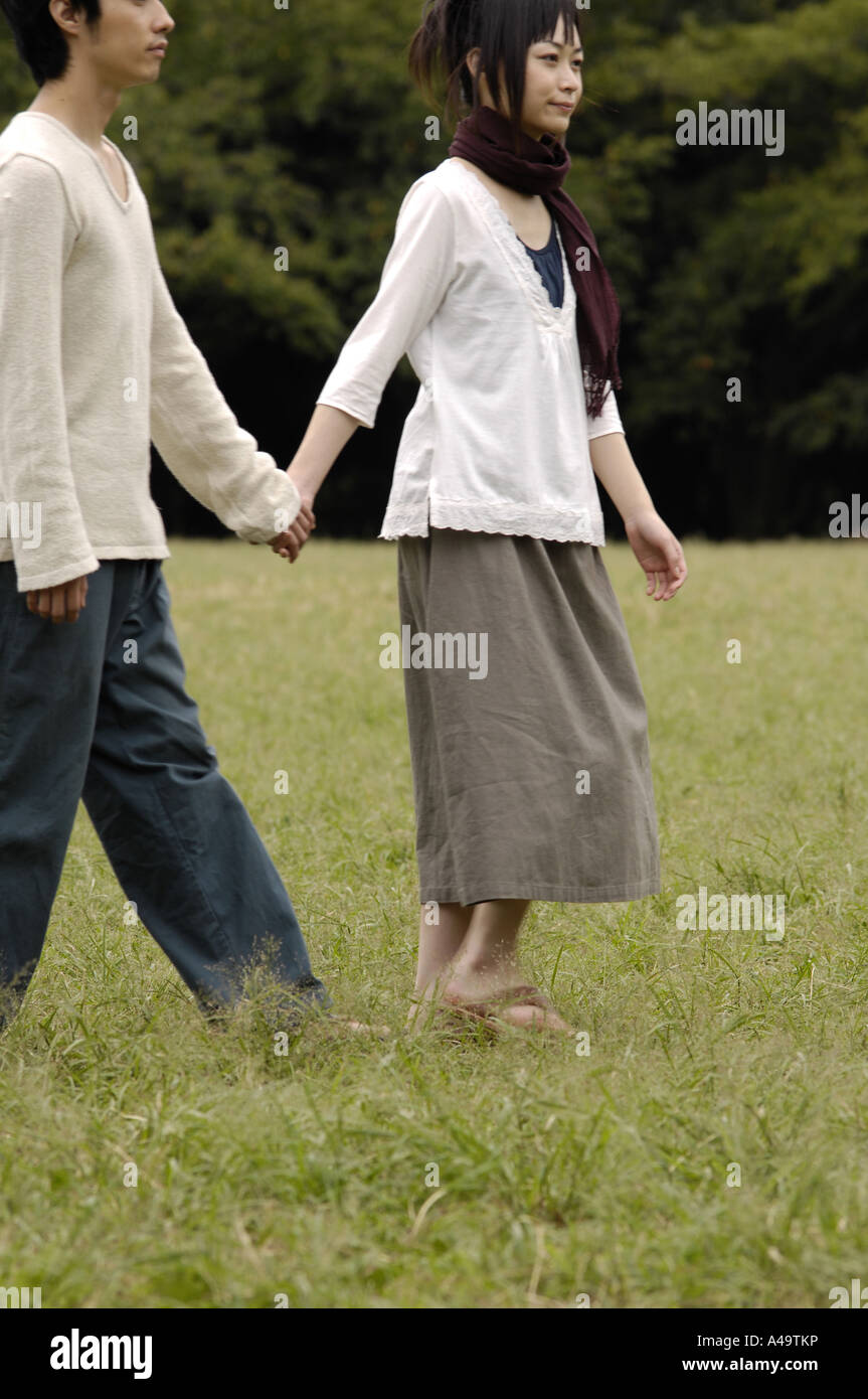 Side profile of a young couple walking together Stock Photo - Alamy