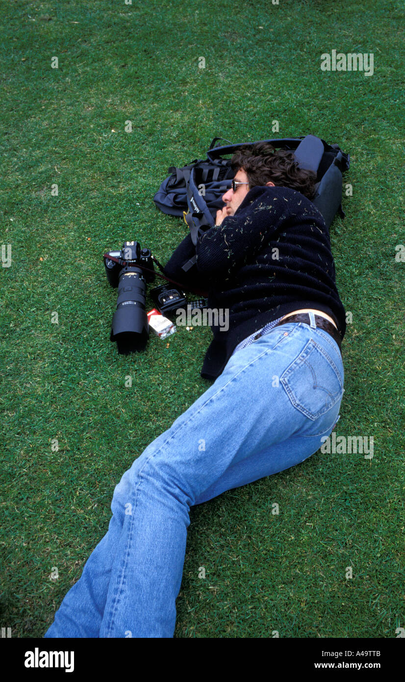 Sleeping photographer on grass Stock Photo - Alamy