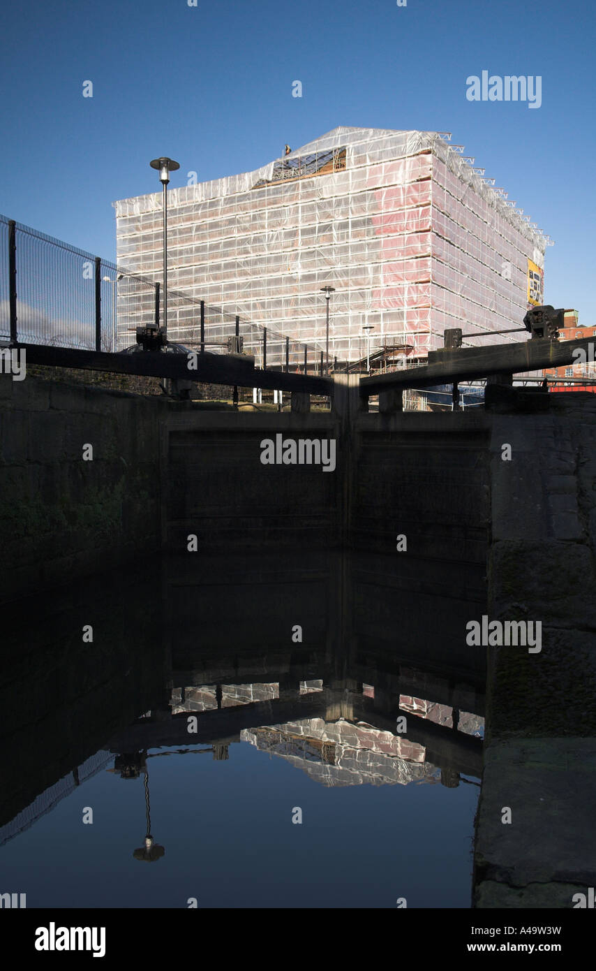 Building covered in scaffolding near the canal lock, Piccadilly Basin ...