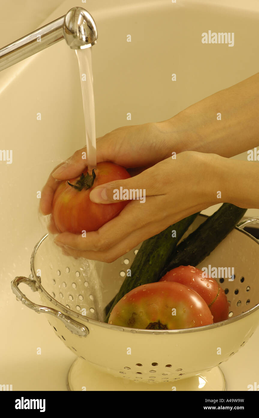 Hands washing vegetables close up hi-res stock photography and images ...