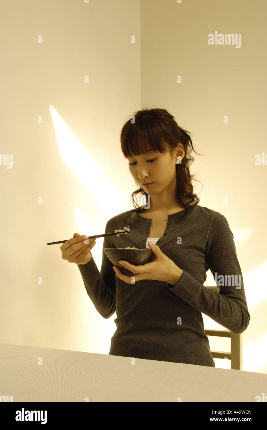 Woman eat brown rice hi-res stock photography and images - Alamy