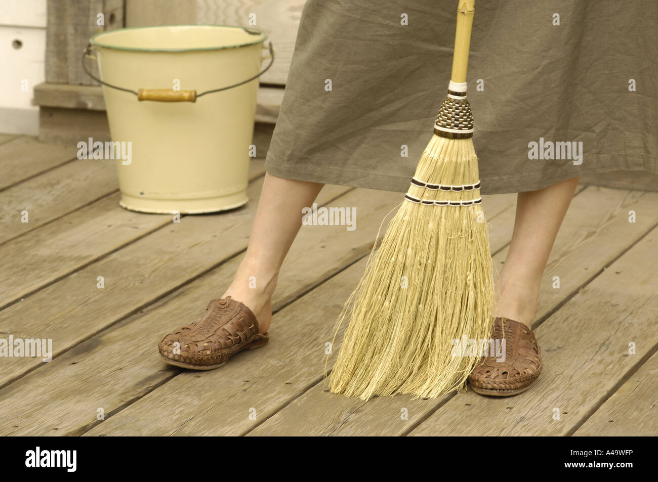 Low section view of a woman with a broom Stock Photo - Alamy
