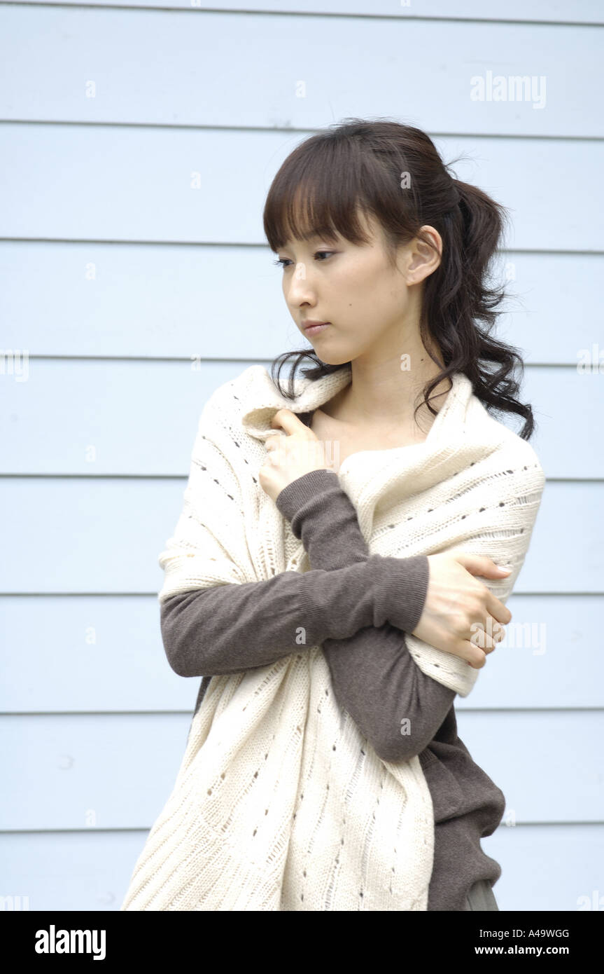 Woman hugging herself outdoors hi-res stock photography and images - Alamy