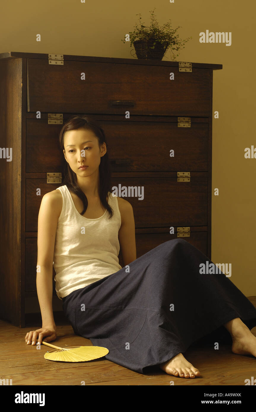 Young woman holding a fan Stock Photo - Alamy